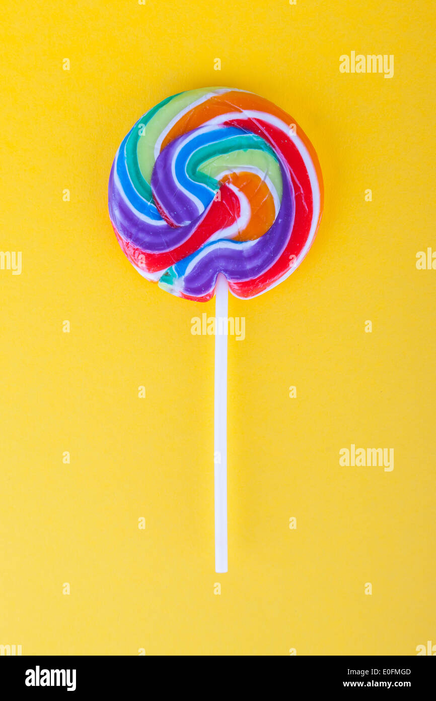 Lollypop isolated on a yellow paper background Stock Photo - Alamy