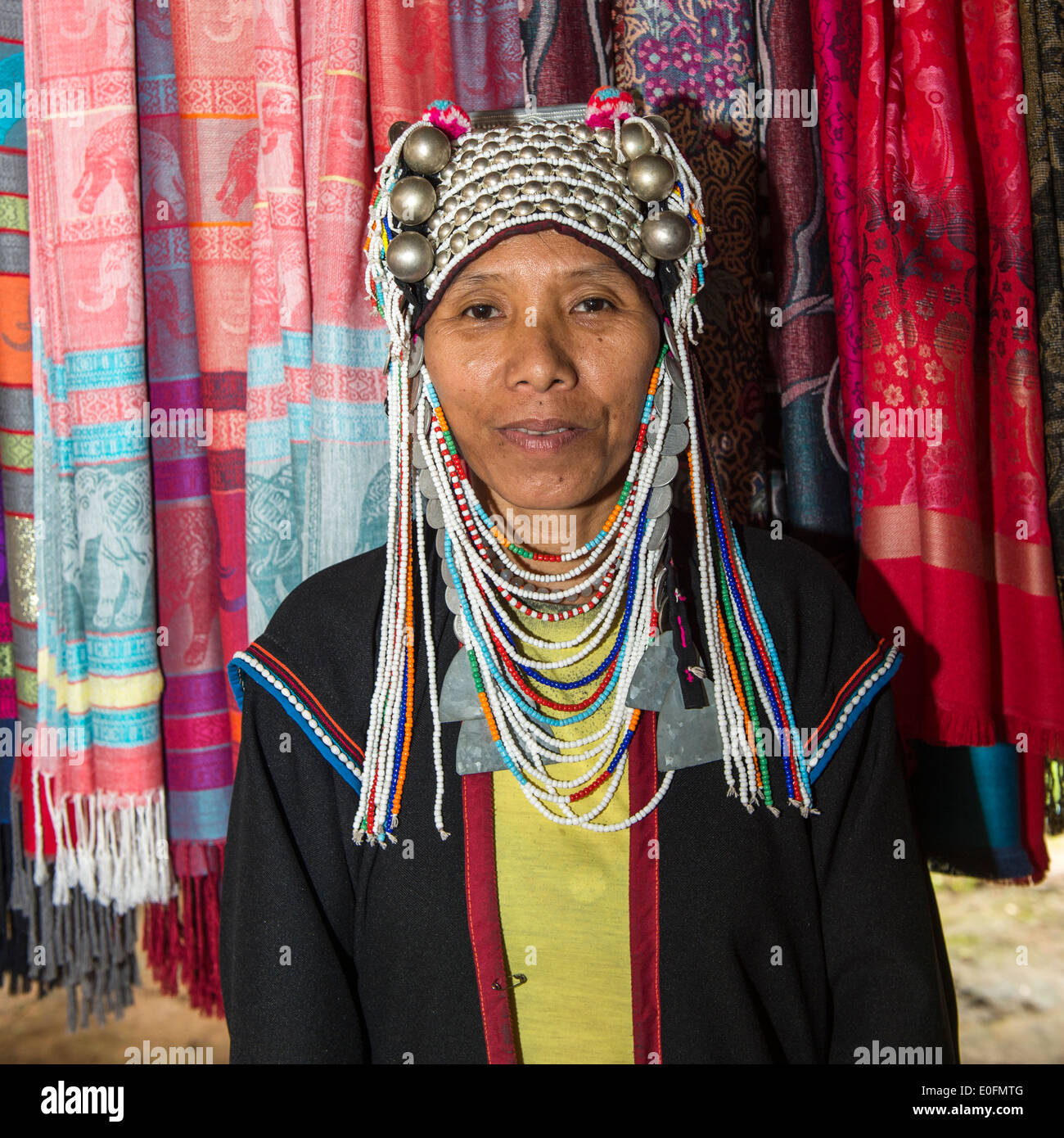 Akha tribeswoman in traditional clothing and wearing an ornate ...