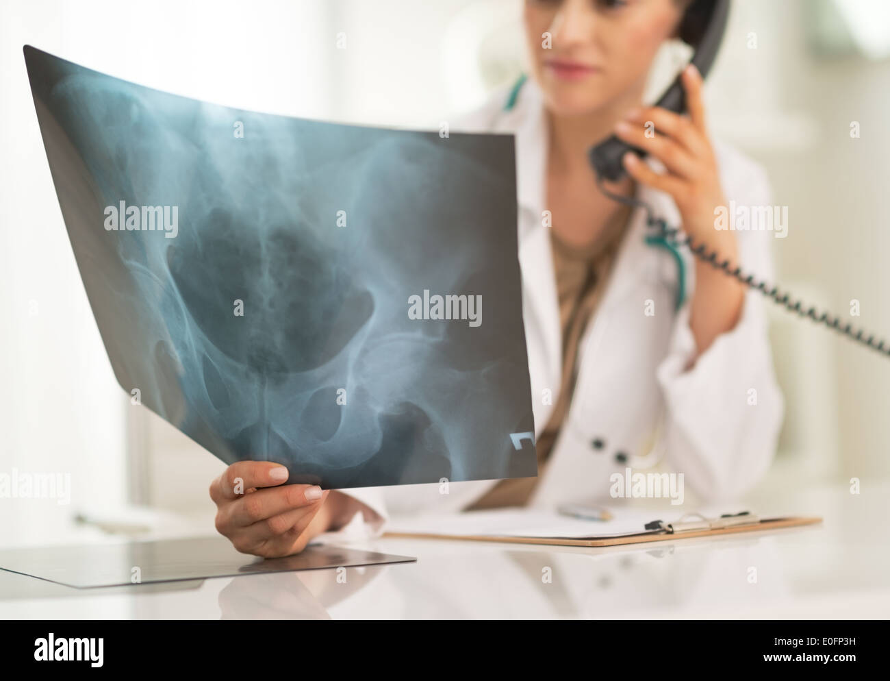 Closeup on medical doctor woman looking on fluorography and talking ...
