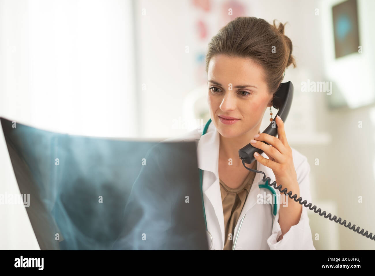 Medical doctor woman looking on fluorography and talking phone Stock ...