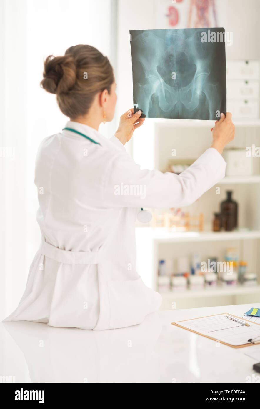 Medical doctor woman looking on fluorography. rear view Stock Photo - Alamy