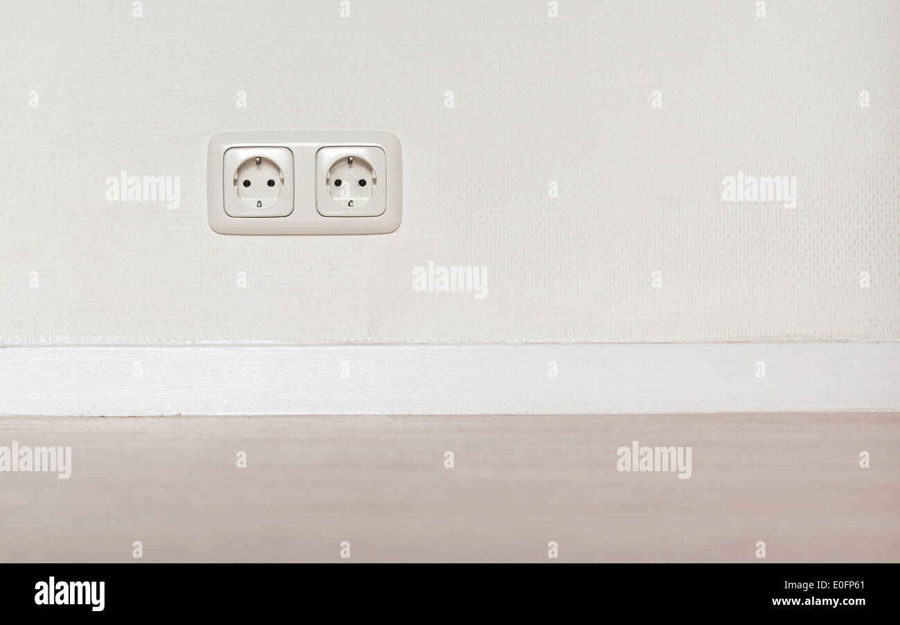 Electrical jack white plastic socket on a white wall Stock Photo - Alamy