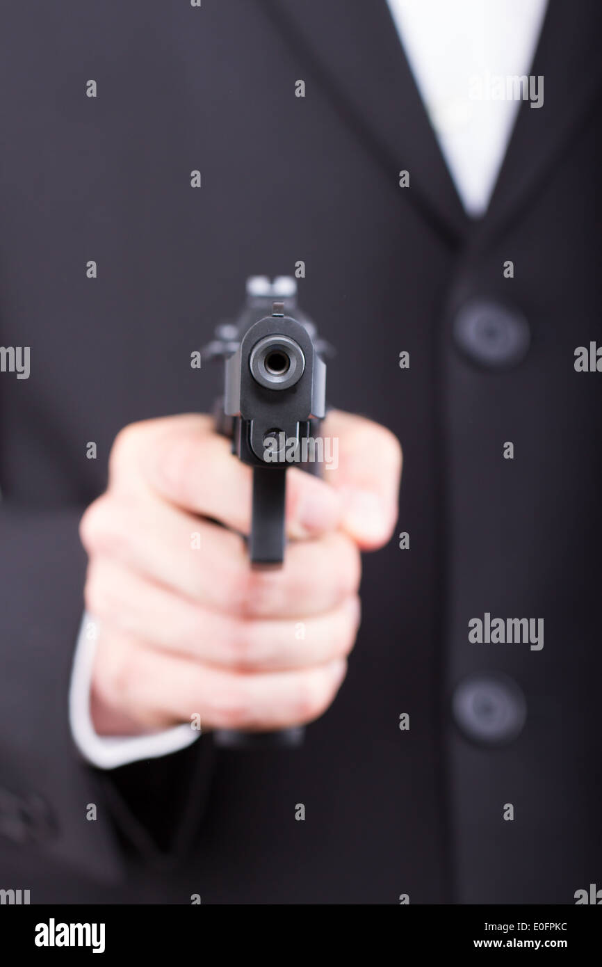 Man with gun, business suit, focus on the gun Stock Photo - Alamy