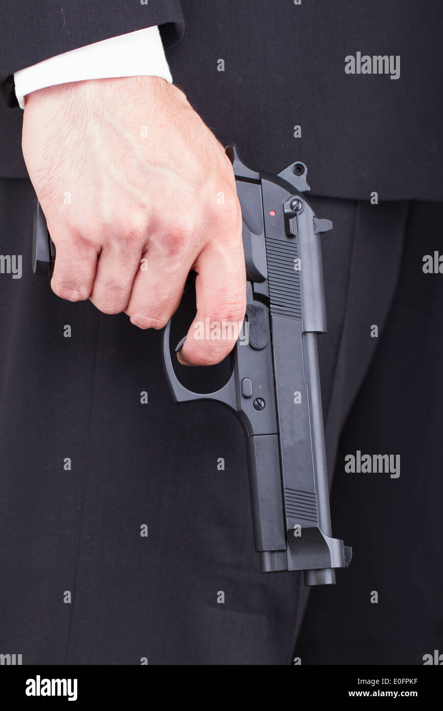 Man with gun, business suit, focus on the gun Stock Photo - Alamy
