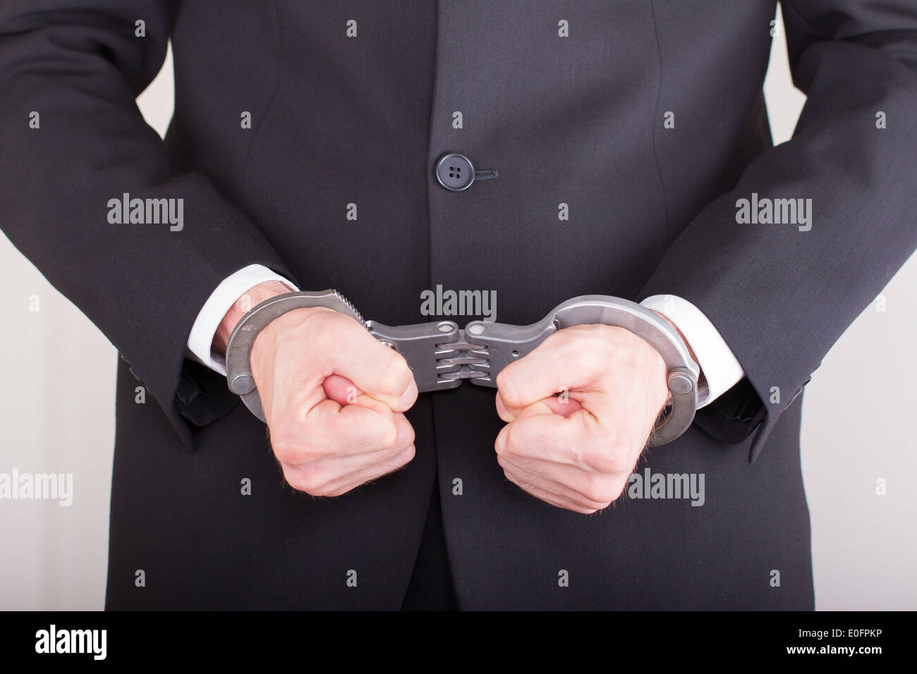Man with handcuffs, business suit, focus on the handcuffs Stock Photo ...