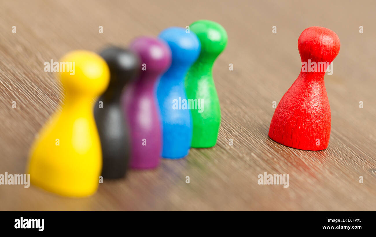 Six colored pawns isolated on a wooden background Stock Photo - Alamy