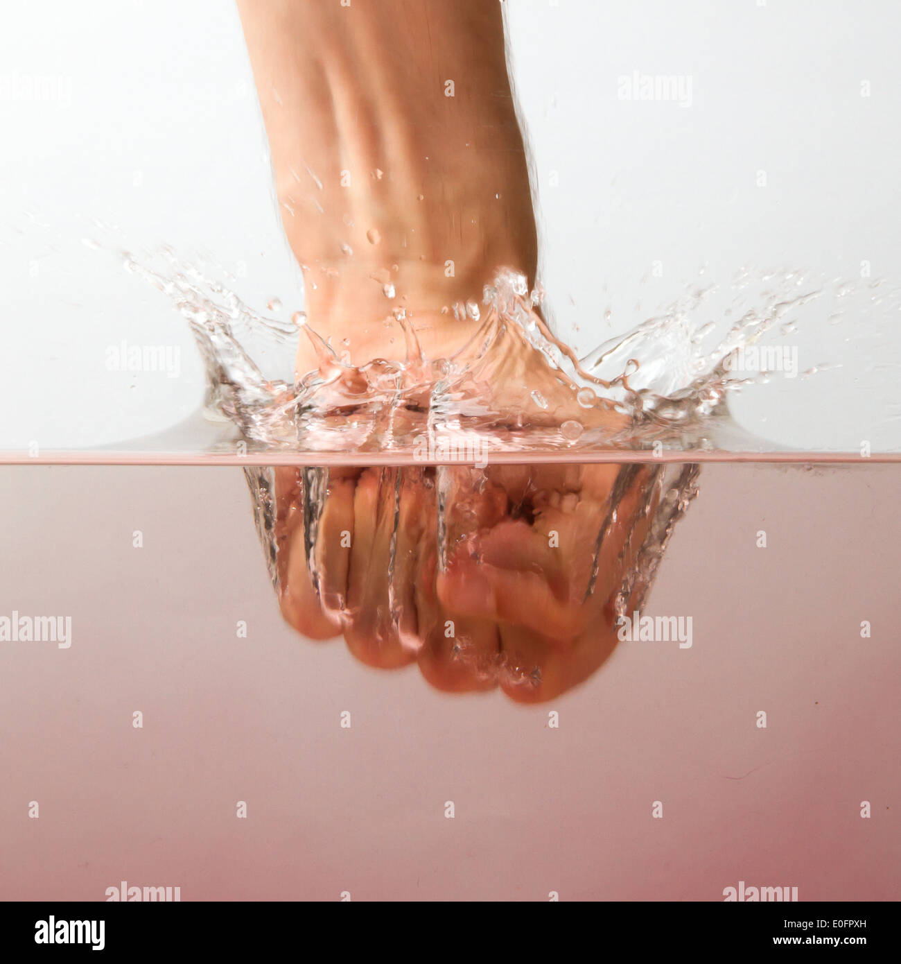 Hand (fist) with splashing red water on a white background Stock Photo ...