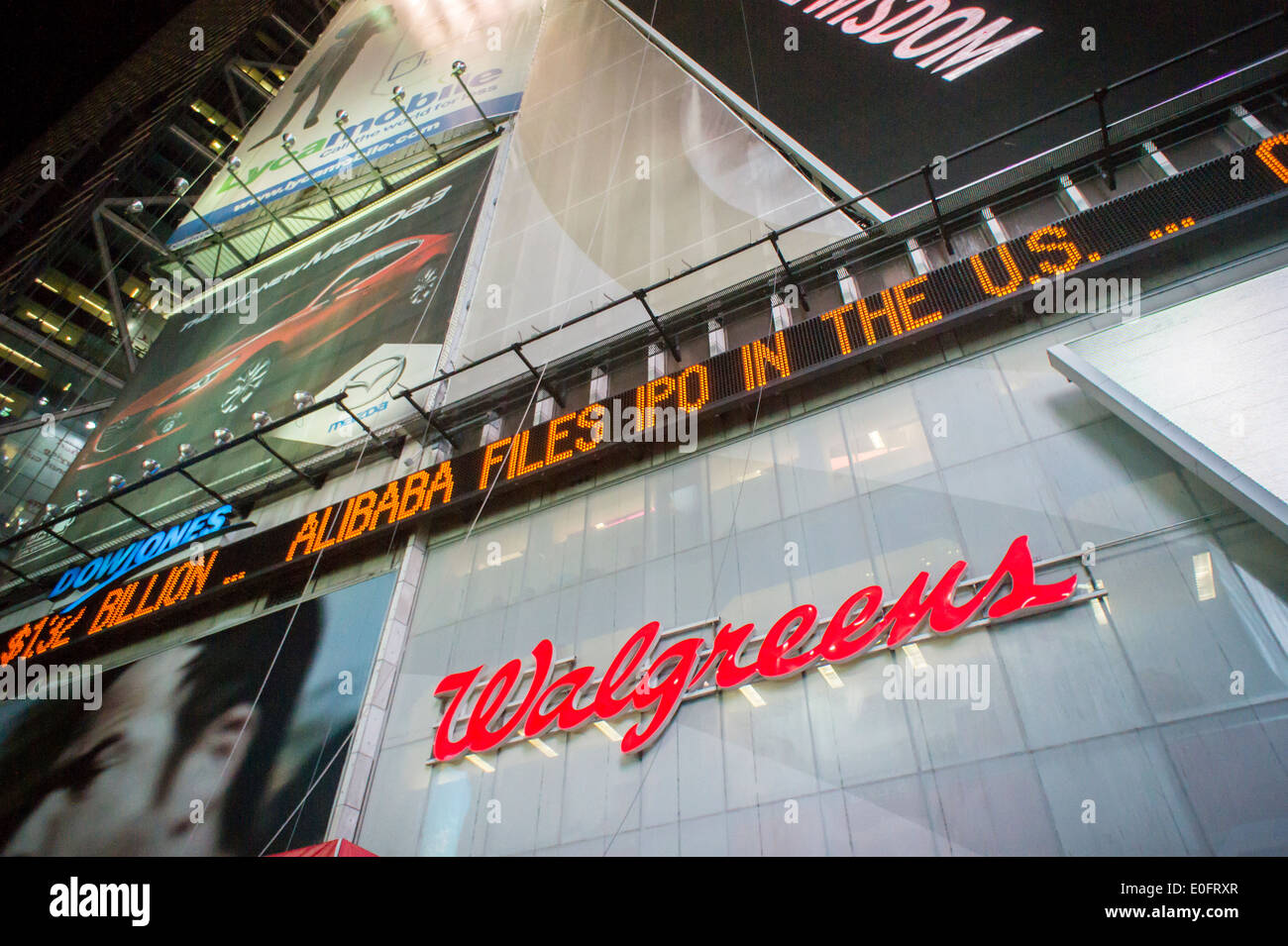 A news ticker in Times Square reports that Alibaba has filed plans for ...