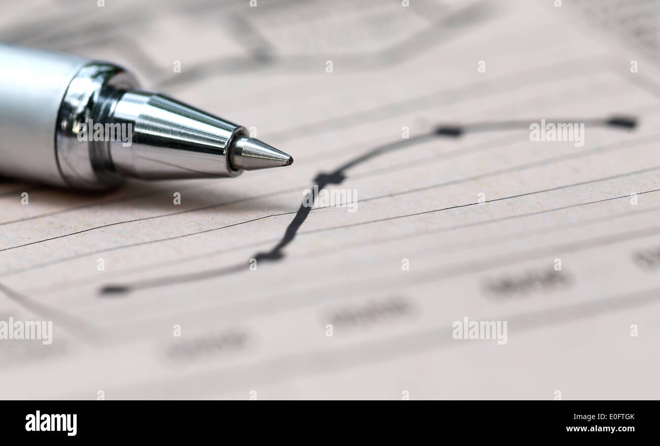 Graph chart with pen on paper Stock Photo - Alamy