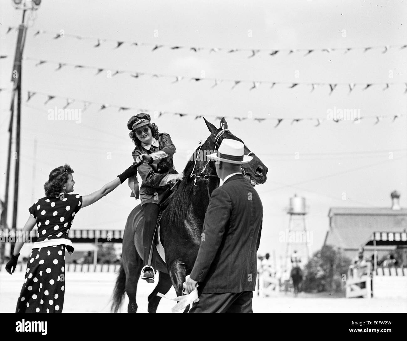 This photo captures a contestant receiving an award ribbon at the Pin ...