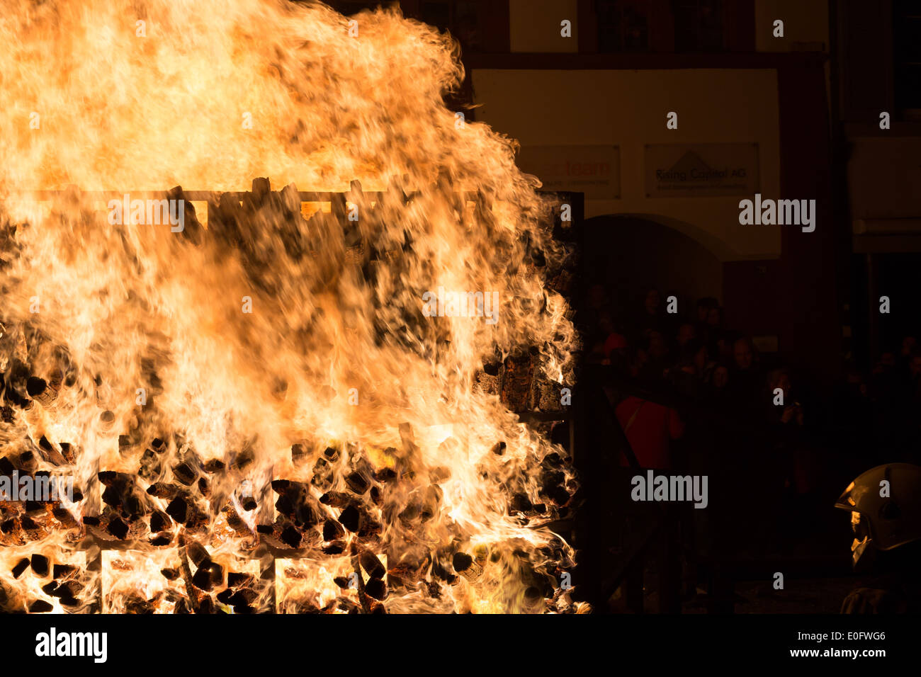 A photograph of fireman next to a bonfire at the festival known as ...