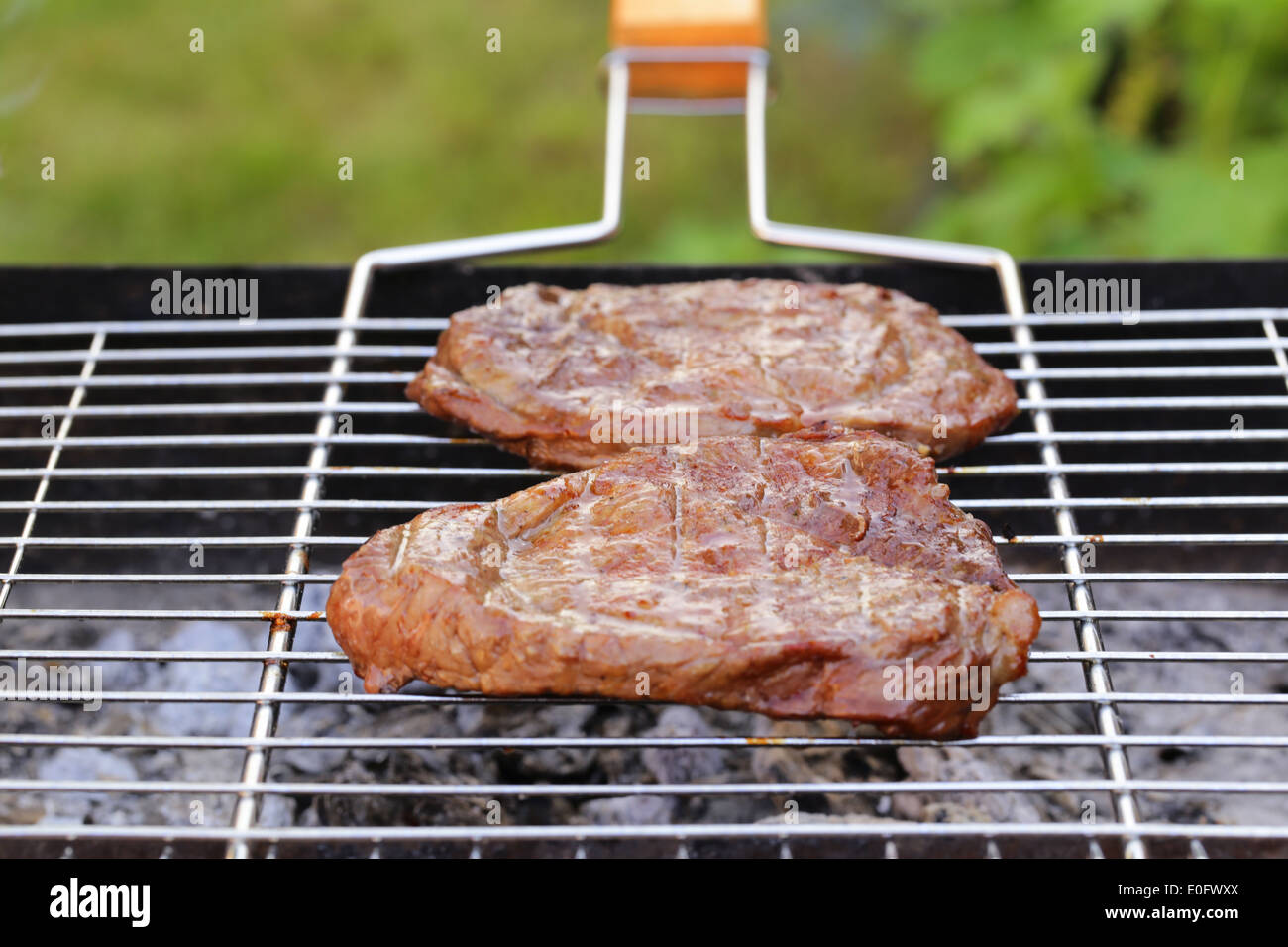 beef steak grilled on a barbecue outdoors Stock Photo - Alamy