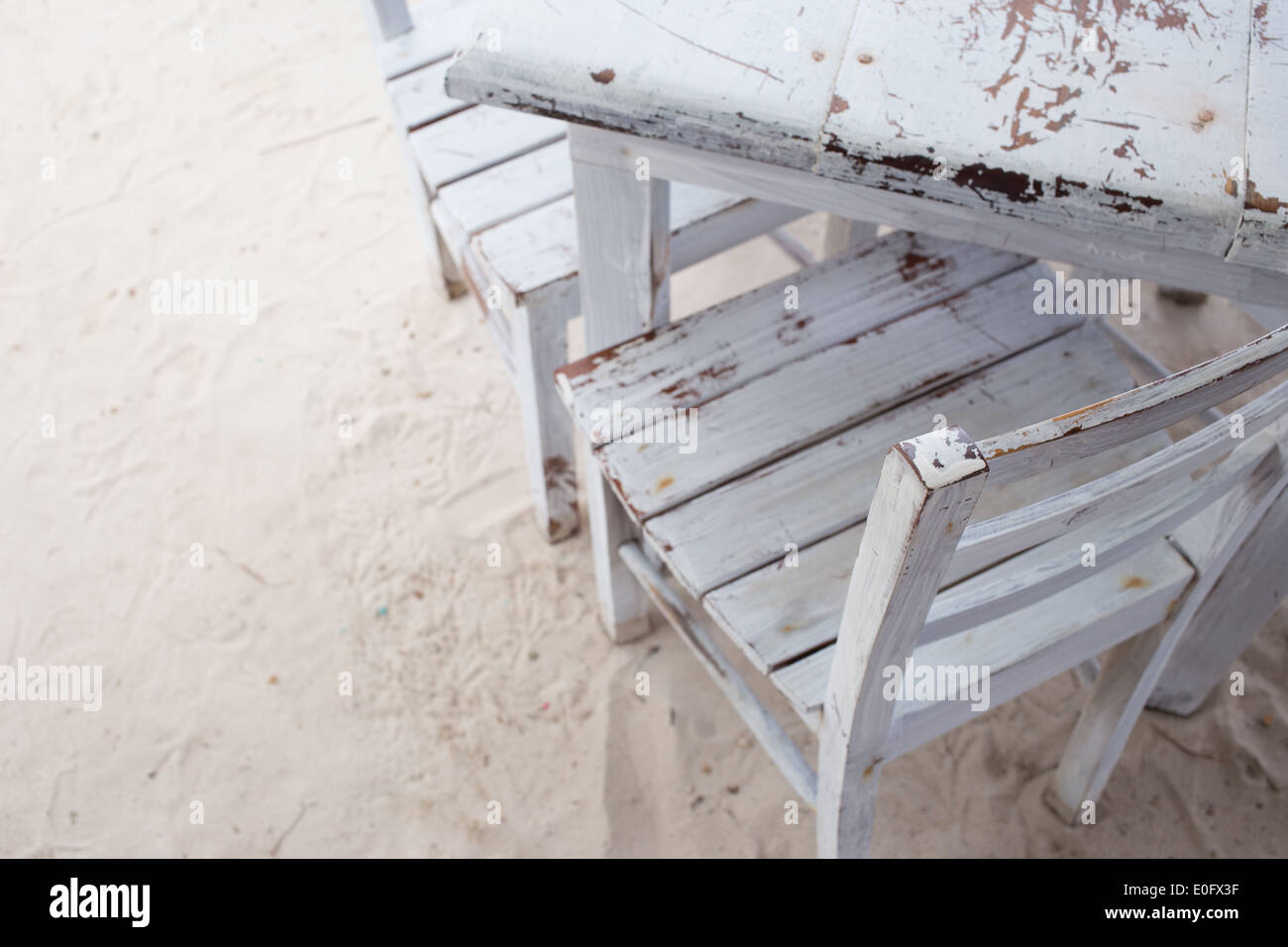 Weathered white wood chairs and table on sand in Mexico Stock Photo - Alamy