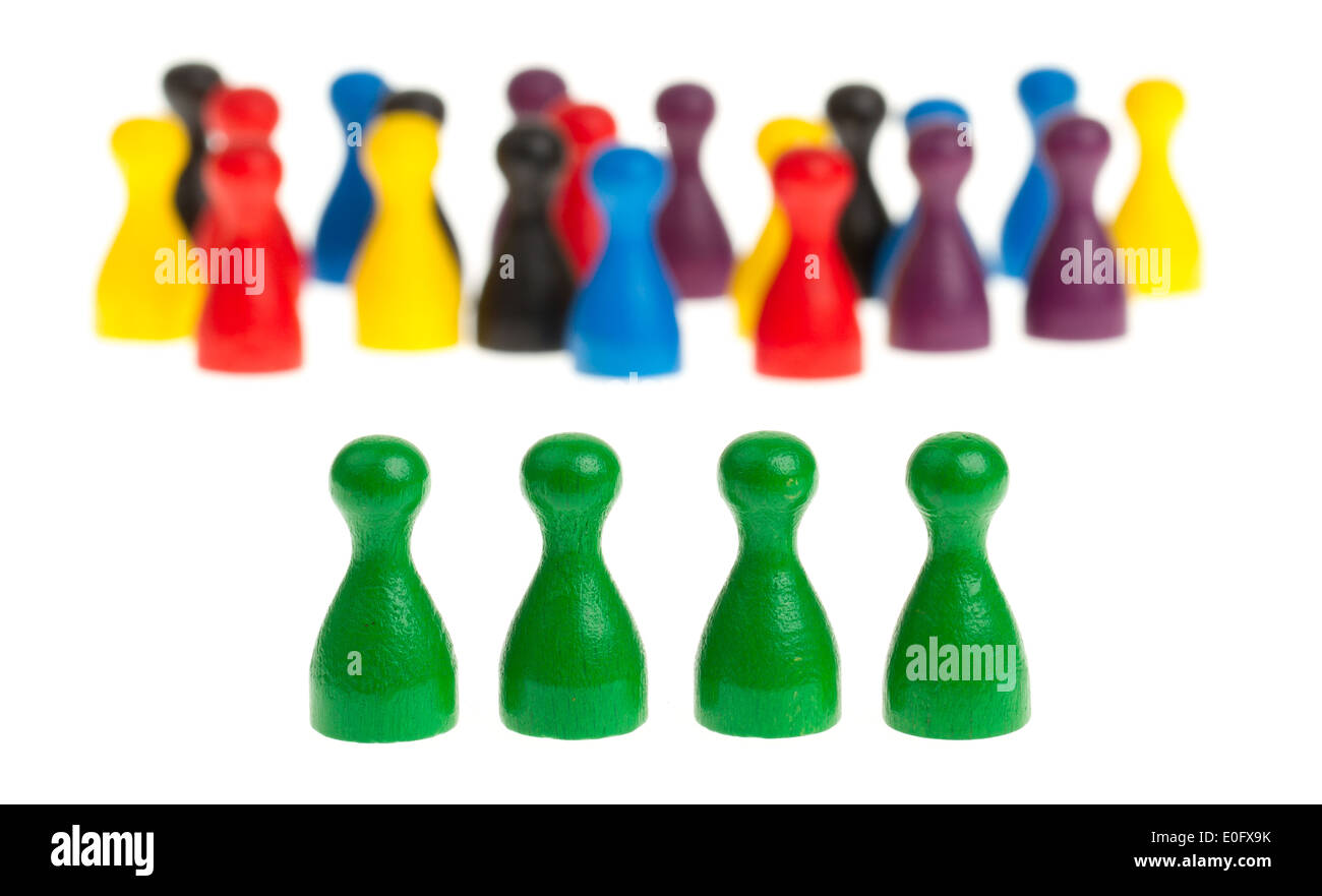 Four green pawns in front of a large group of different colored pawns ...