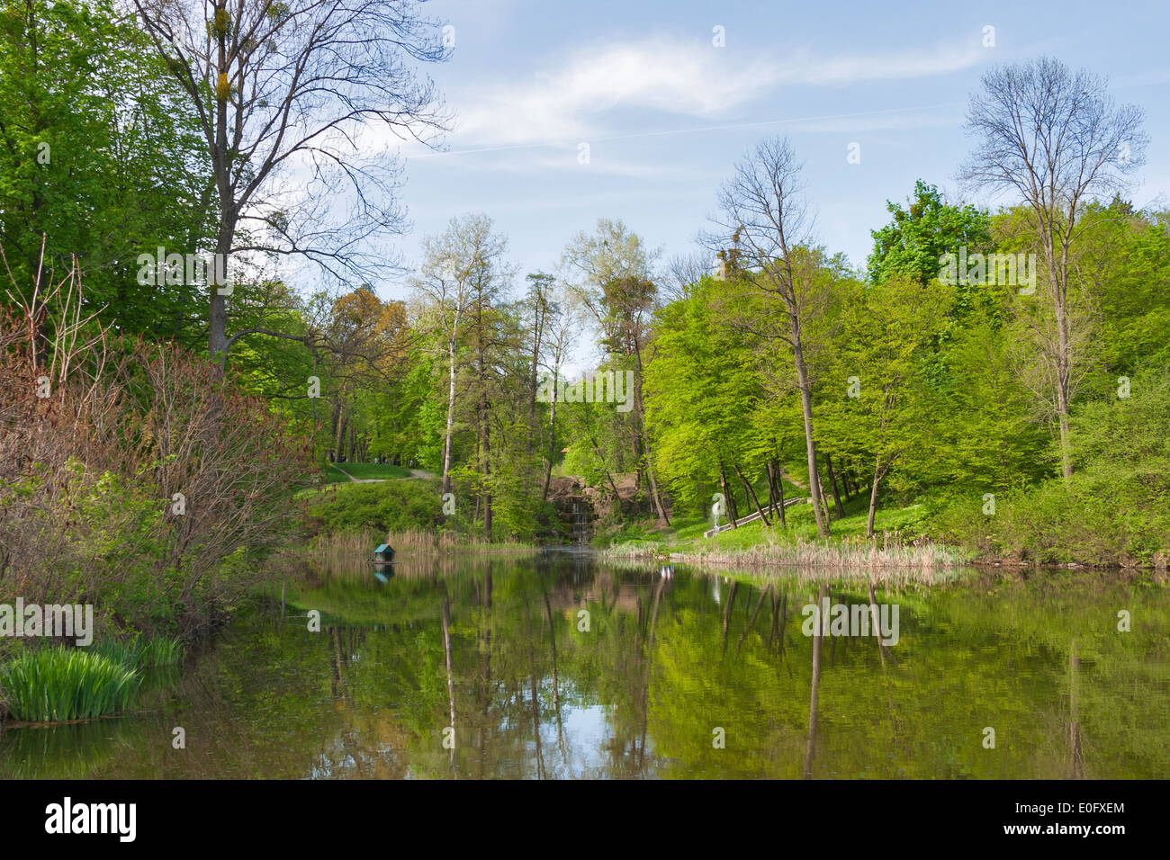 old spring park with a pond, small waterfall and house for ducks Stock ...