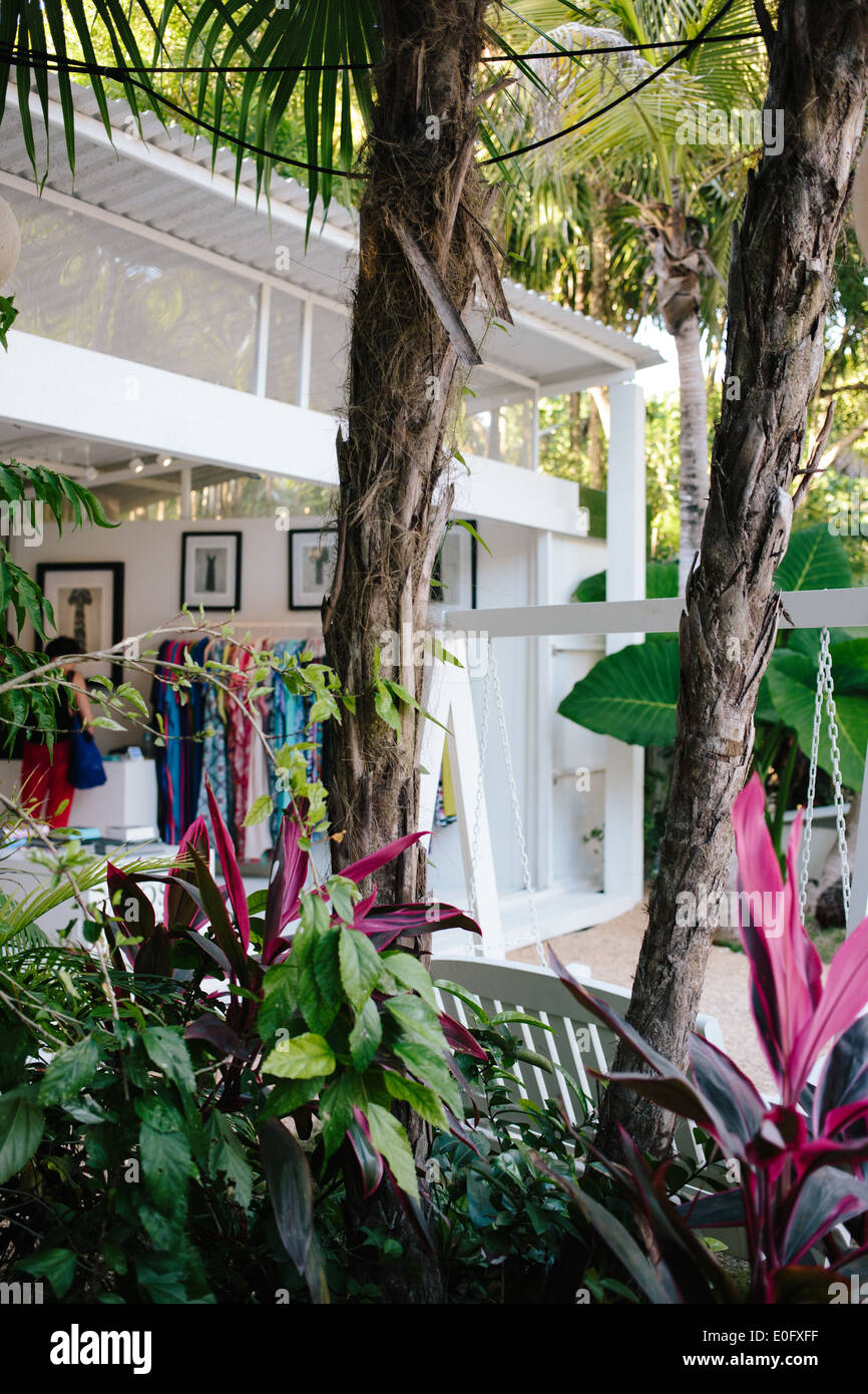 View of upscale boutique selling colorful tropical apparel in white ...