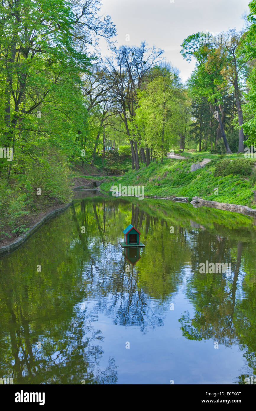old spring park with a pond and house for ducks Stock Photo - Alamy