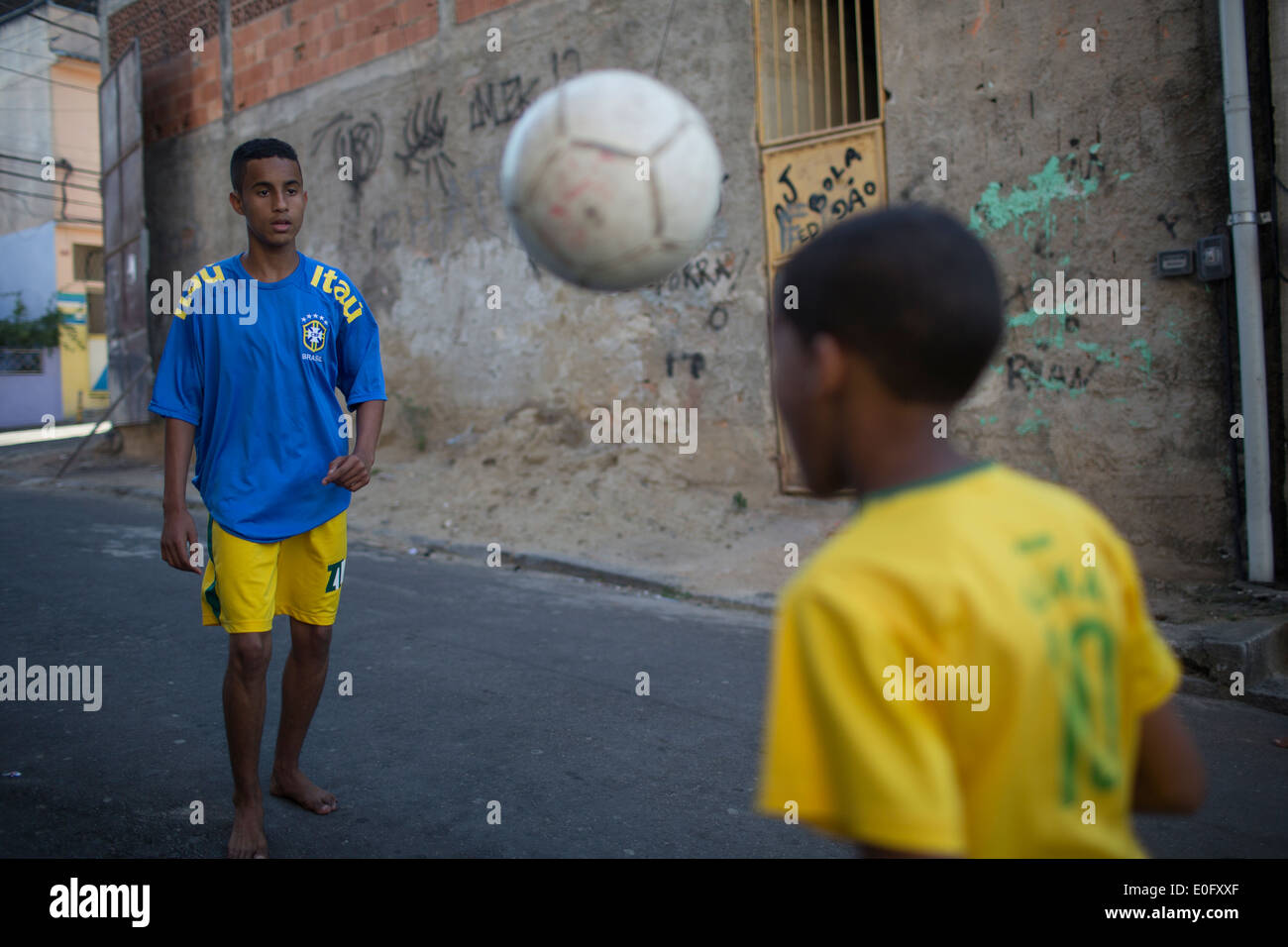 Brazilian boys playing football in a favela street of Rio de Janeiro ...