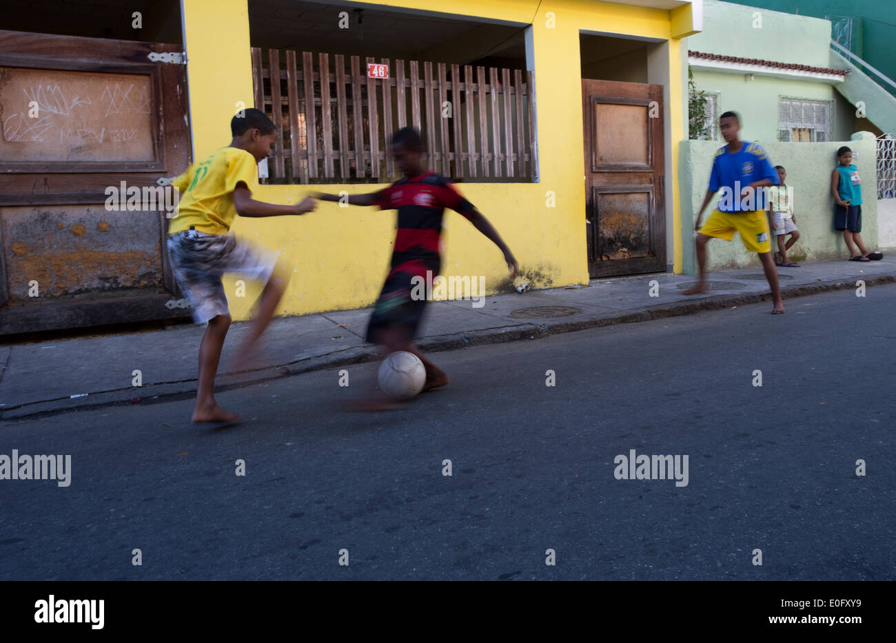 Brazilian boys playing football in a favela street of Rio de Janeiro ...