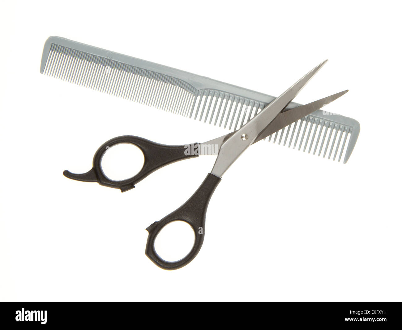Hair cutting shears and comb isolated on white Stock Photo - Alamy