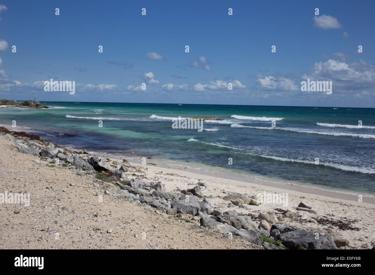 Road along Tulum beach with blue sky, clouds, and waves Stock Photo - Alamy