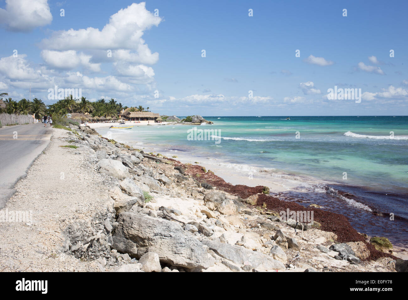 Road along Tulum beach with blue sky, clouds, and waves Stock Photo - Alamy