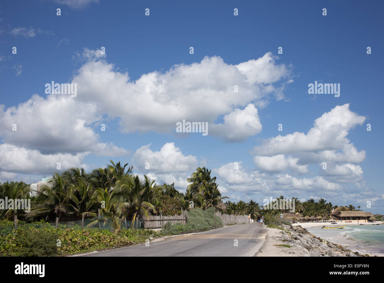 Road along Tulum beach with blue sky, clouds, and waves Stock Photo - Alamy