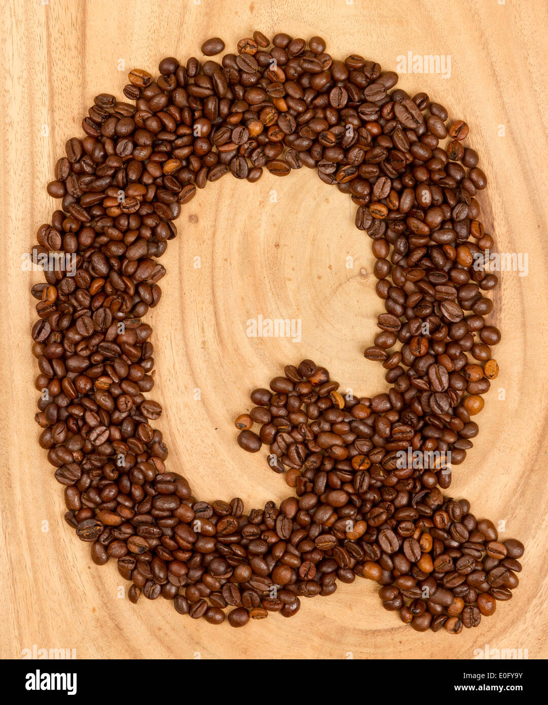 Letter Q, alphabet from coffee beans. isolated on wood Stock Photo - Alamy