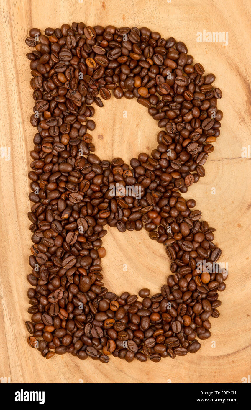Letter B, alphabet from coffee beans. isolated on wood Stock Photo - Alamy