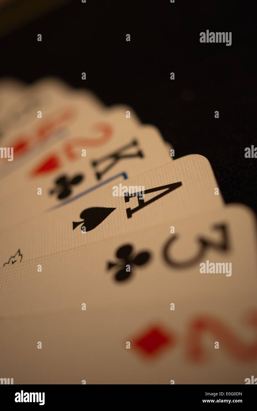 Playing cards spread out with selective focus against a black ...
