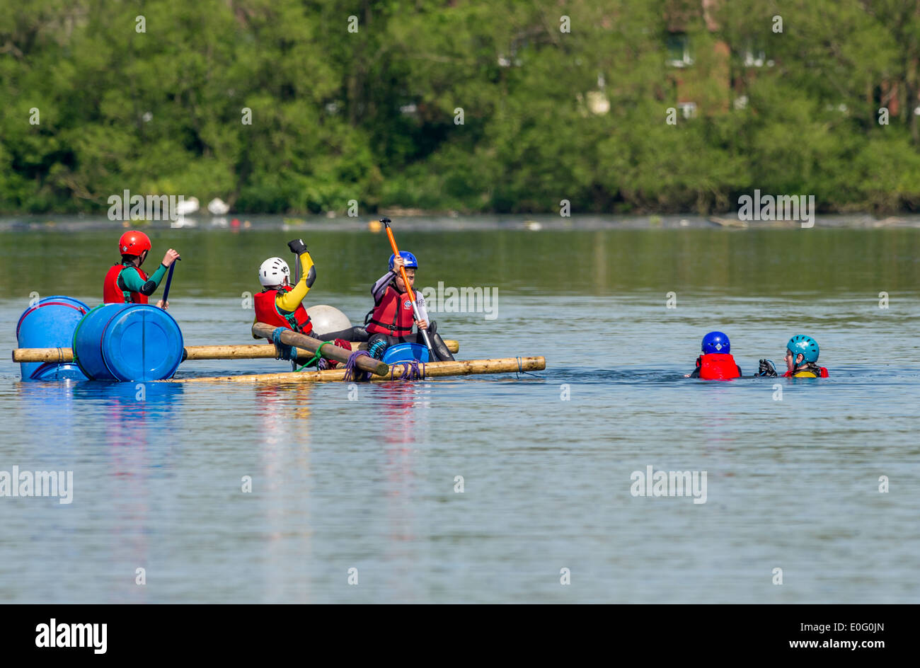 Young teenagers canoing on a make shift raft at a local lake Stock ...