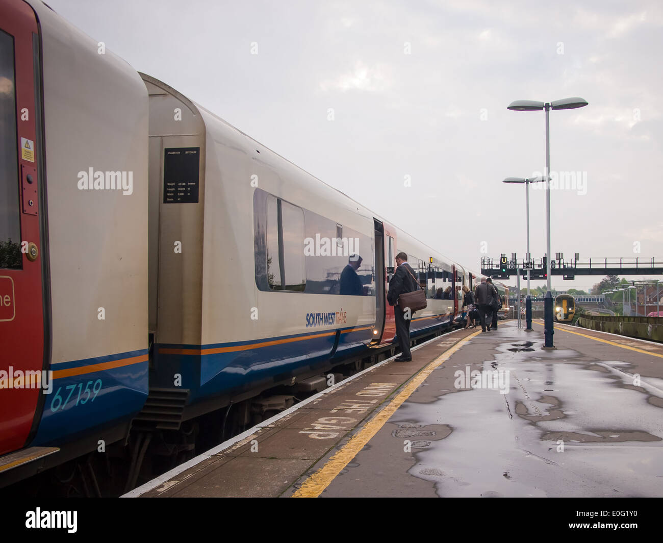 A train at a platform at Portsmouth Harbour Station on a rainy day ...
