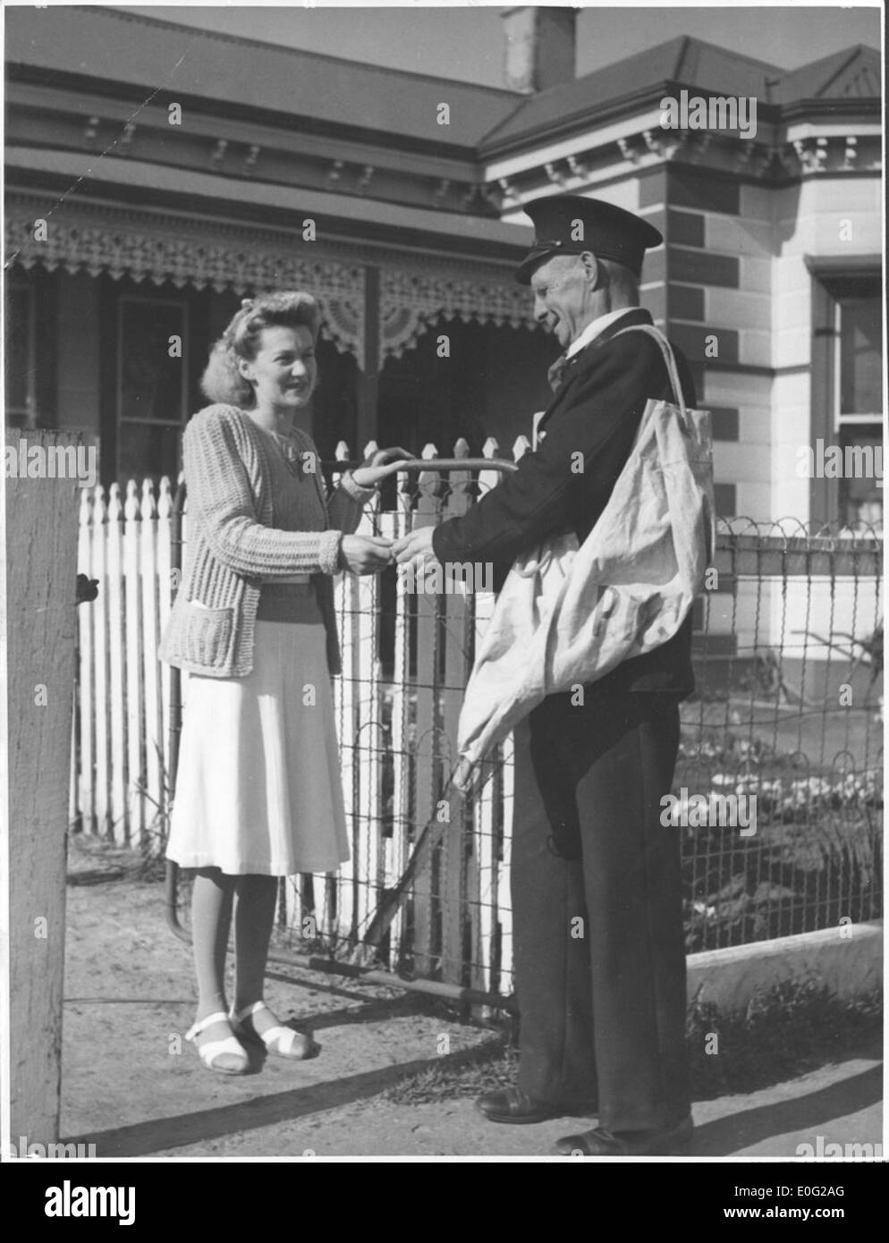Mail carrier delivering mail Black and White Stock Photos & Images - Alamy
