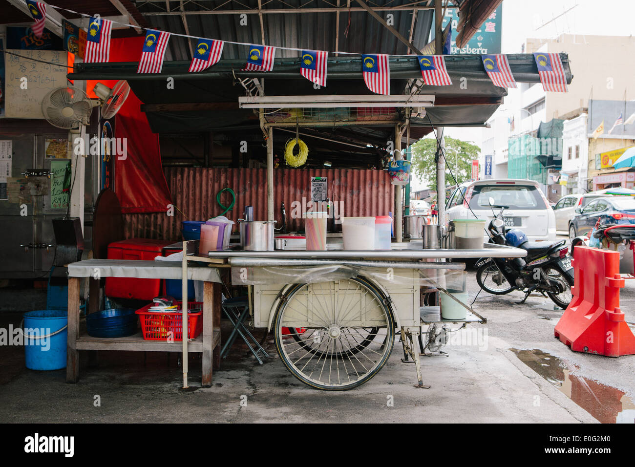 Empty hawker stand in Georgetown, Penang with row of Malaysian flags ...