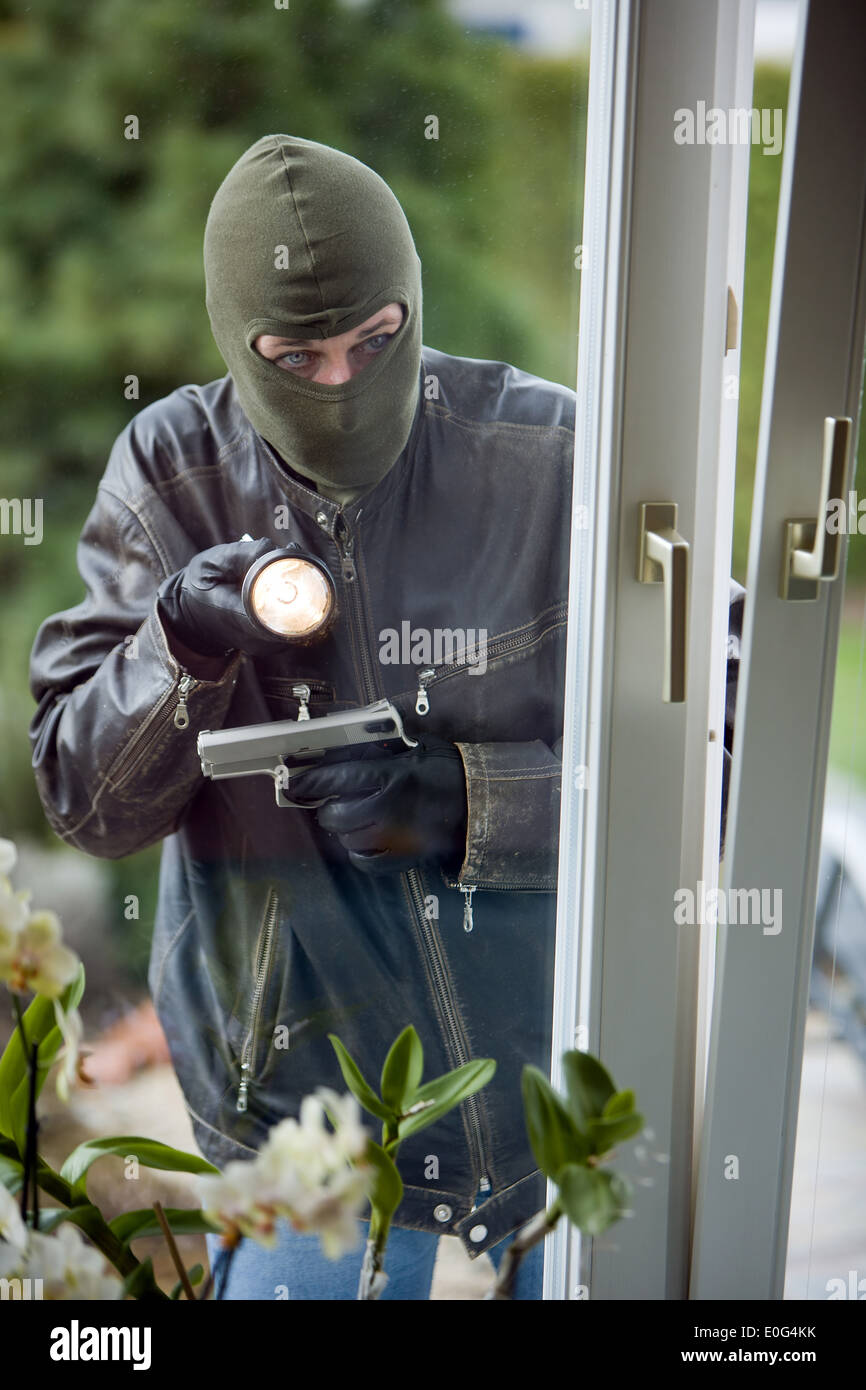Burglar at a window housebreaker burglary Stock Photo - Alamy