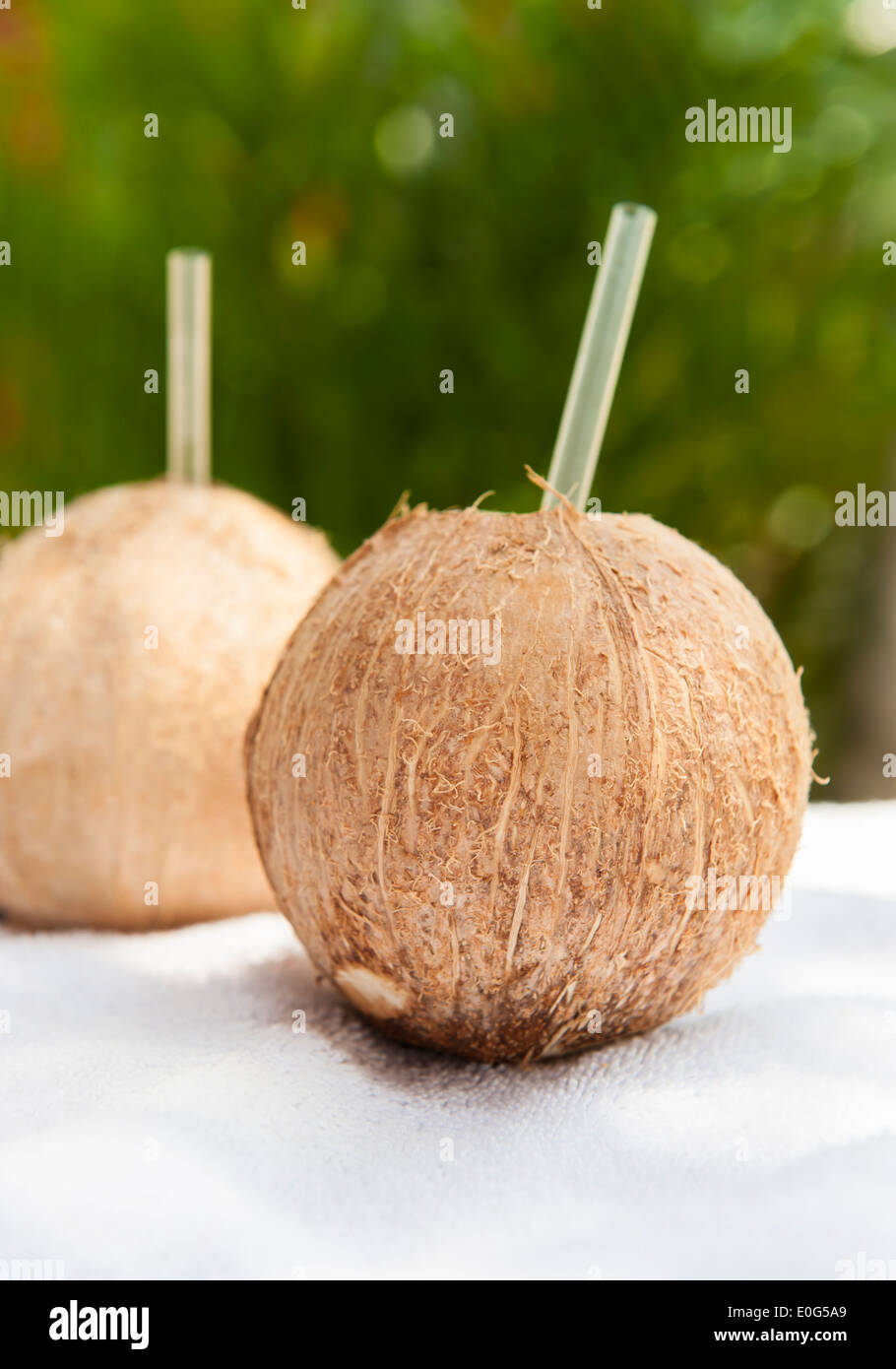 Coconut water drinks with palm tree background Stock Photo - Alamy