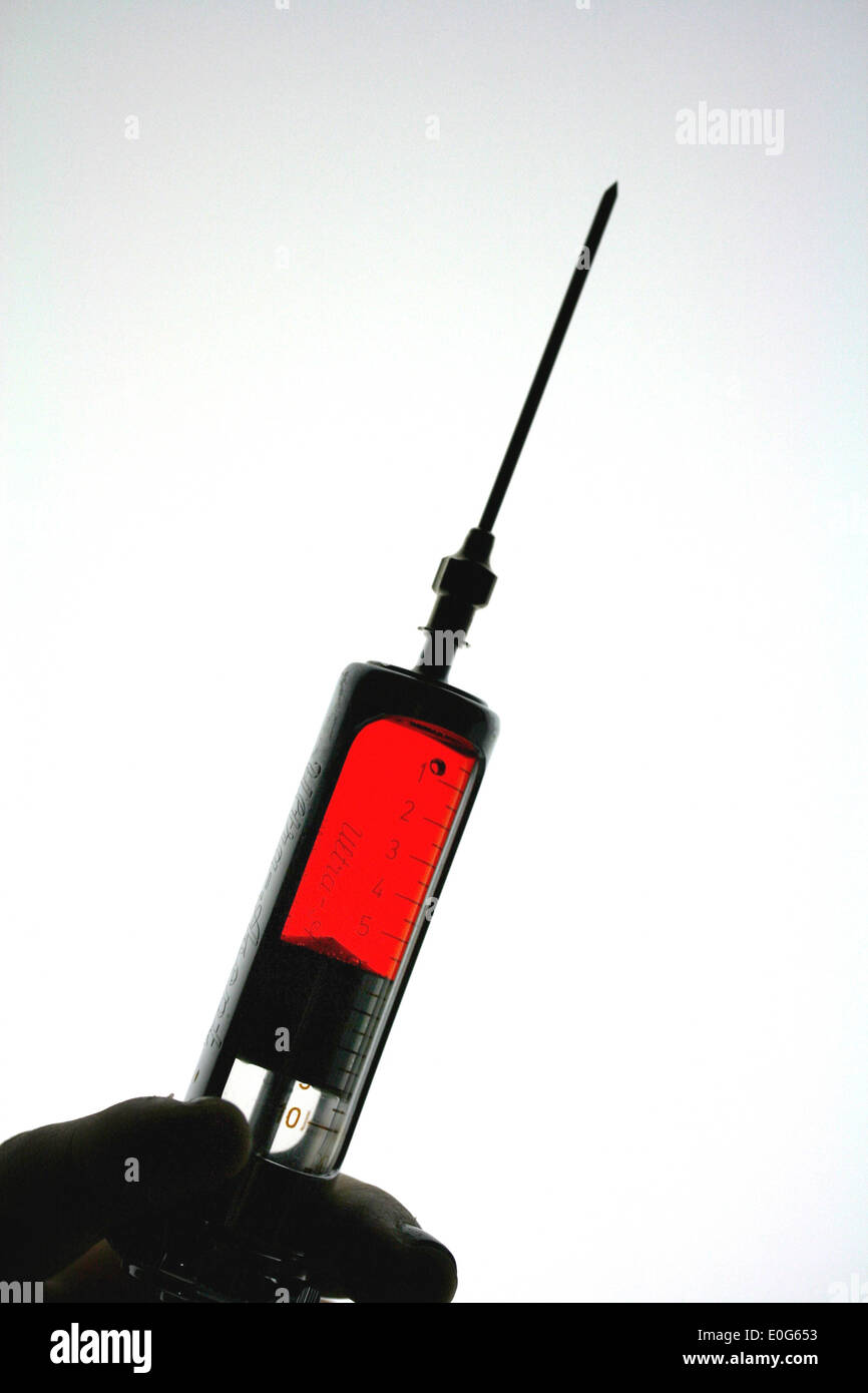Syringe with red liquid Stock Photo - Alamy