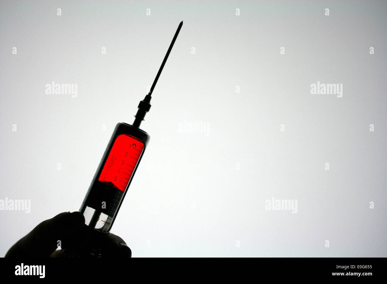 Syringe with red liquid Stock Photo - Alamy
