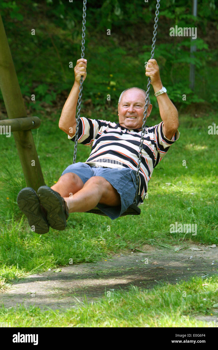 Laughing boss on swing Stock Photo - Alamy
