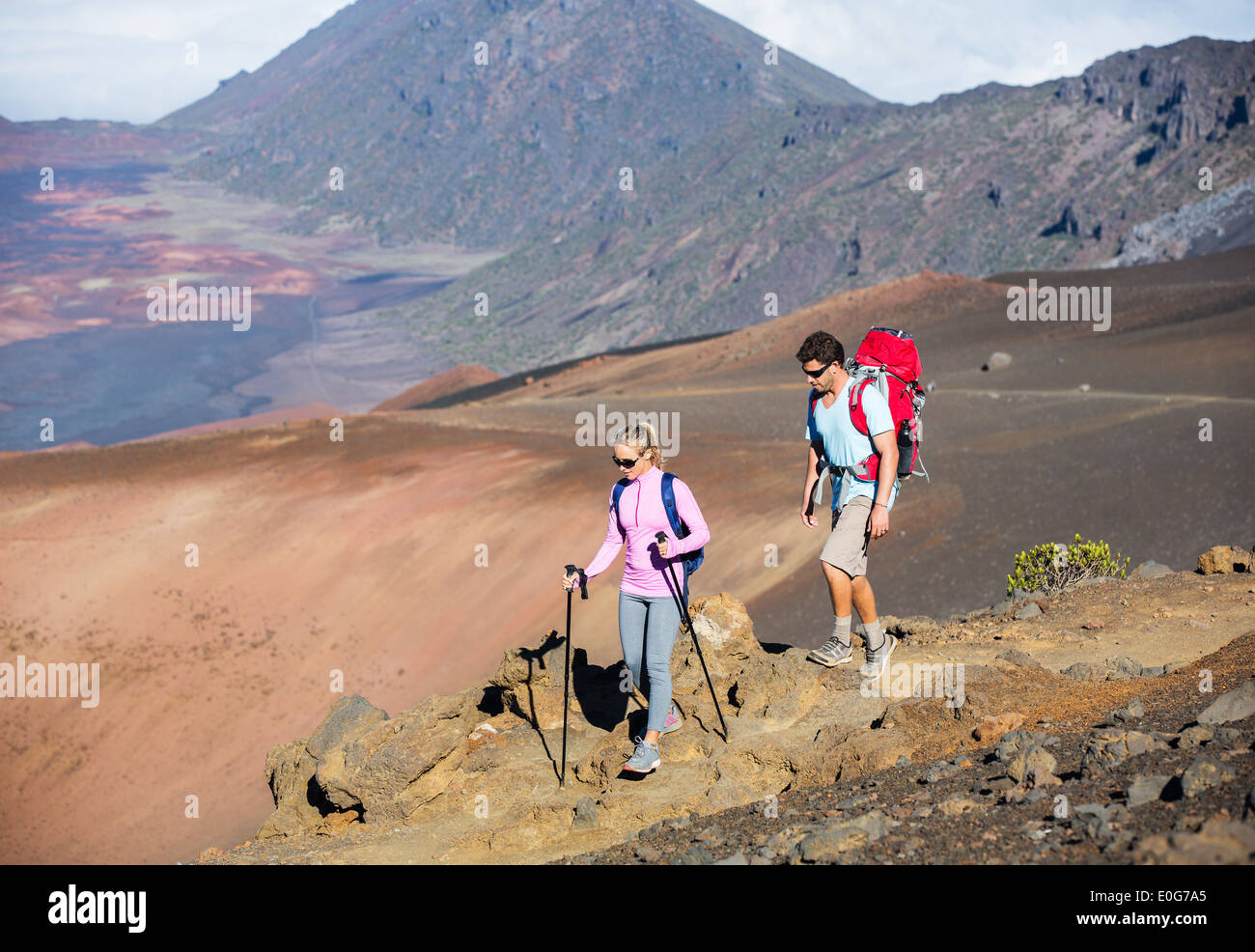 Man and woman hiking on beautiful mountain trail. Trekking and ...