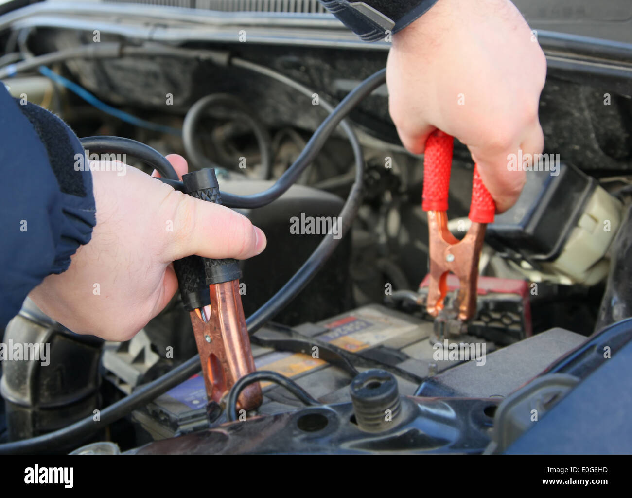Close up photo of how mechanic charges the battery car Stock Photo - Alamy