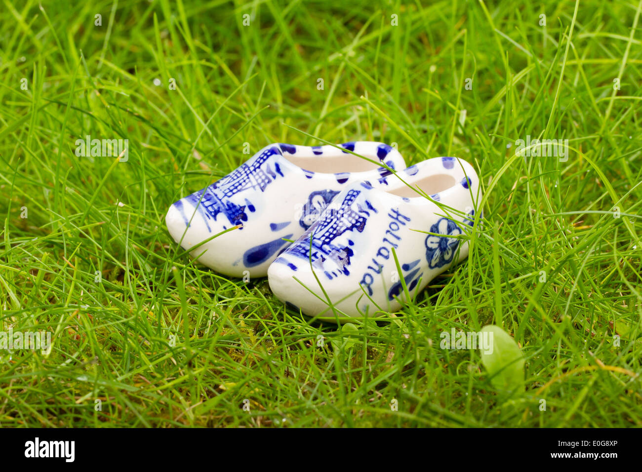 Pair of small porcelain clogs from Holland, isolated in grass Stock ...