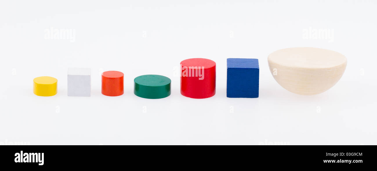 Wooden blocks in the different shapes, isolated on white Stock Photo ...