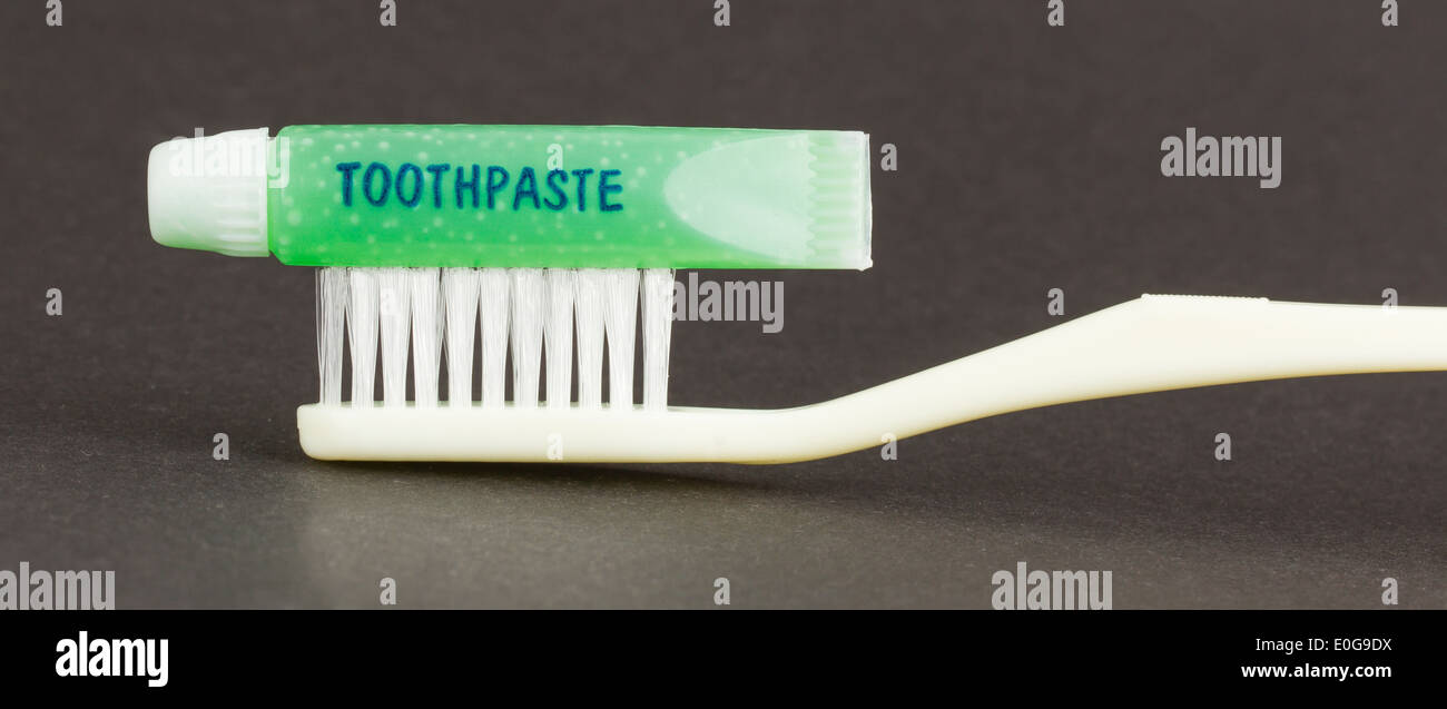 Toothbrush and green toothpaste isolated on a grey background Stock ...