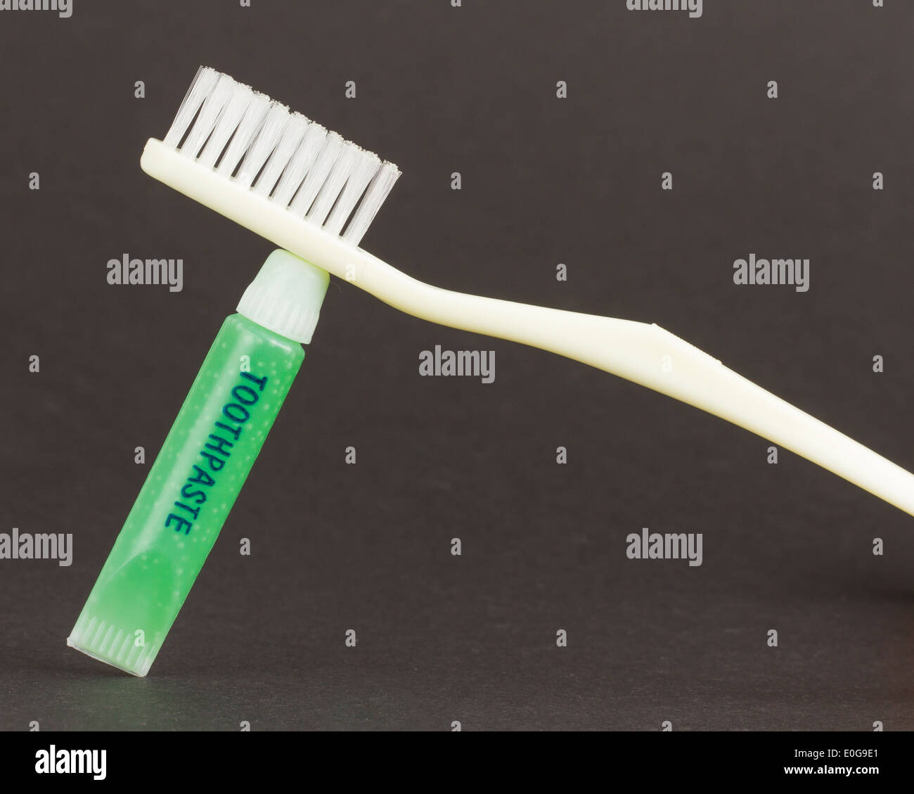 Toothbrush and green toothpaste isolated on a grey background Stock ...
