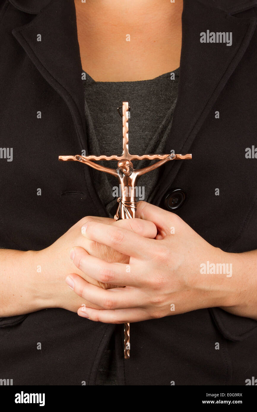 Woman in black with the cross in hands, isolated Stock Photo - Alamy