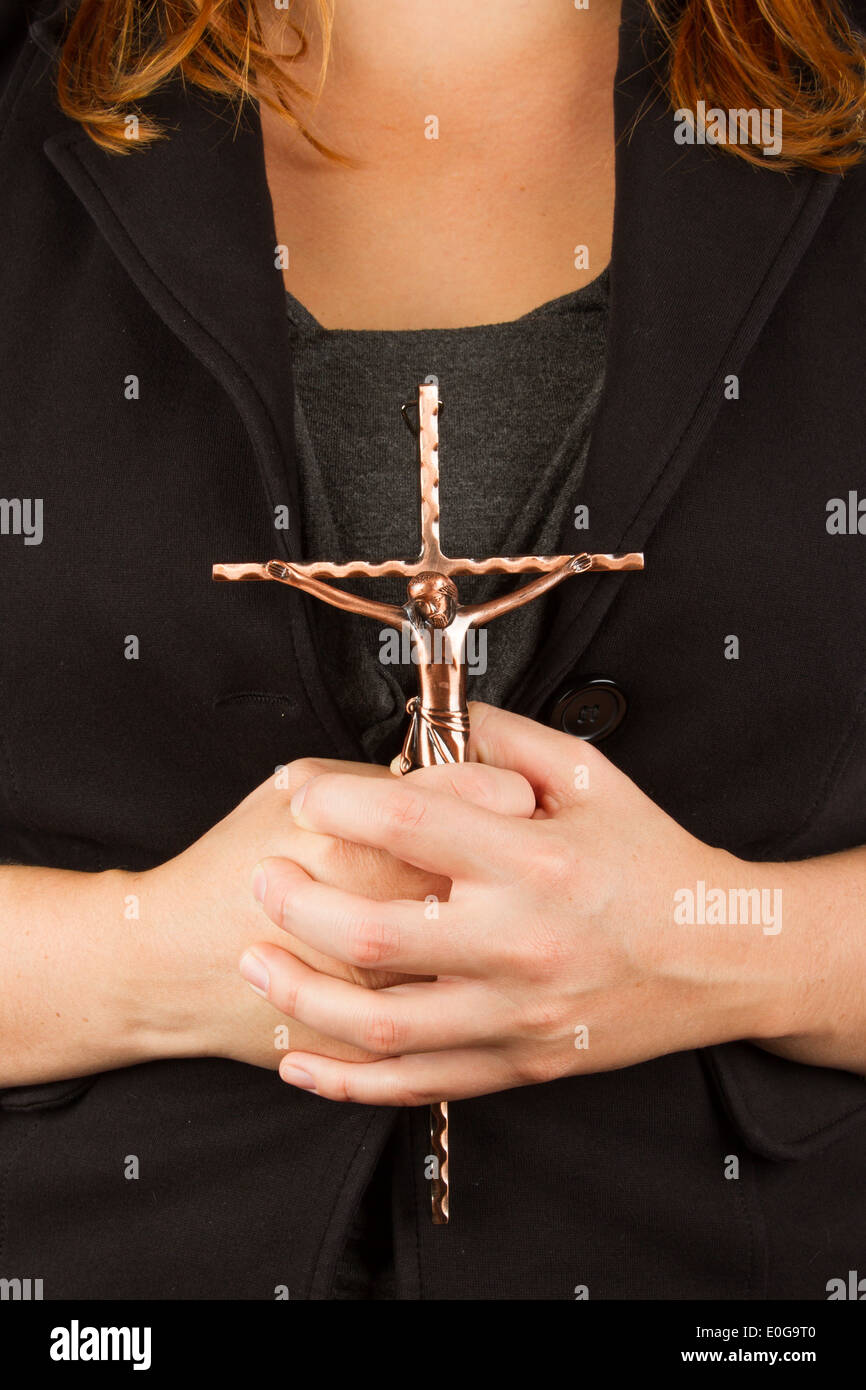 Woman in black with the cross in hands, isolated Stock Photo - Alamy