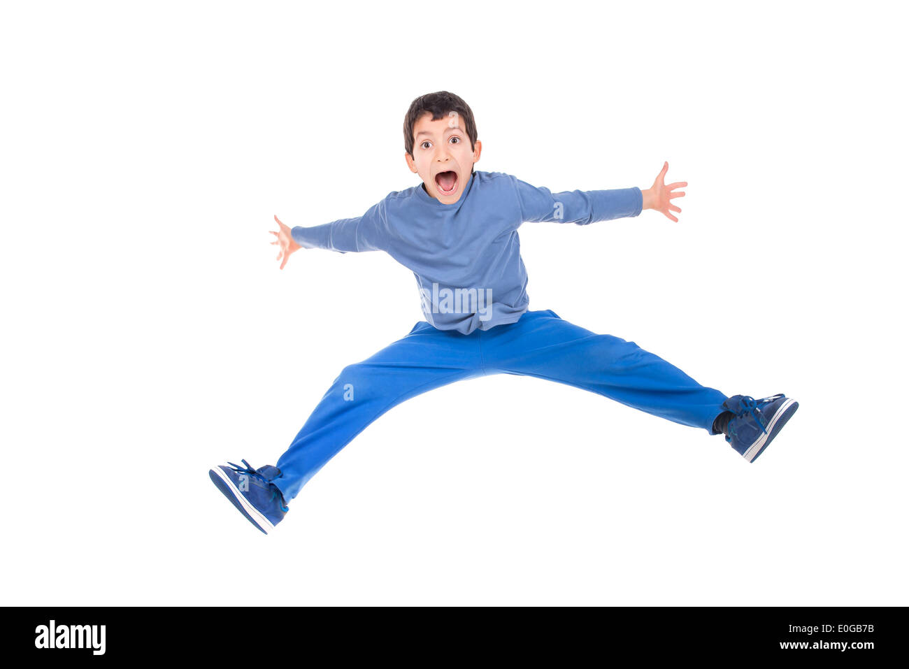 Young boy jumping isolated in white Stock Photo - Alamy