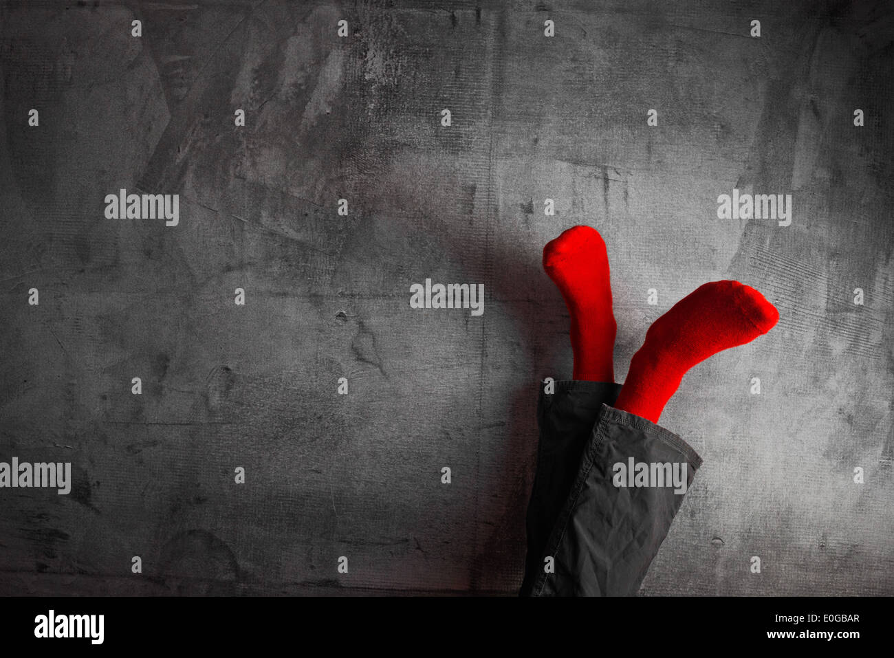 Legs up the wall, putting feet up. Man wearing red socks in relaxing ...