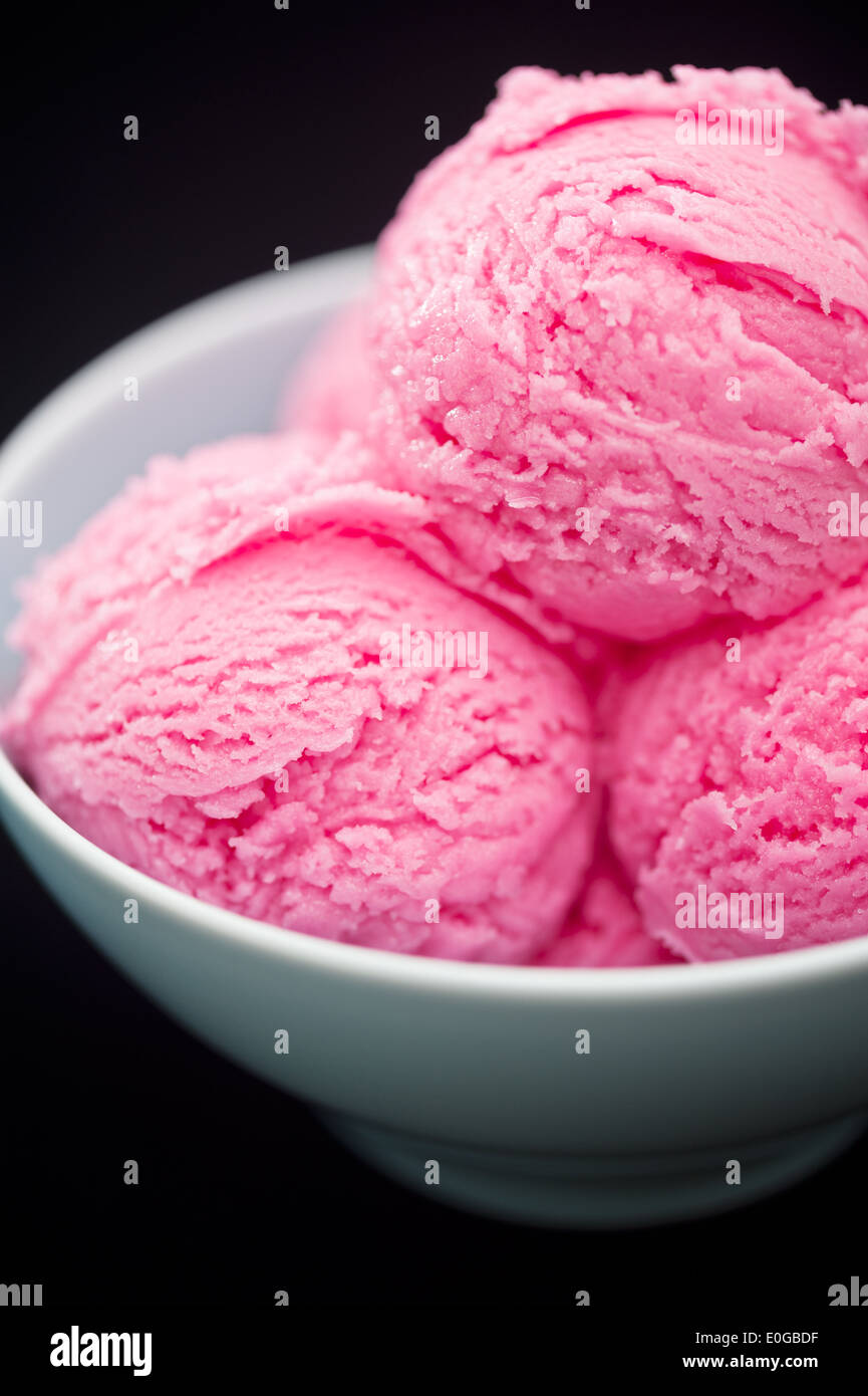 Strawberry ice cream cup over black background Stock Photo - Alamy